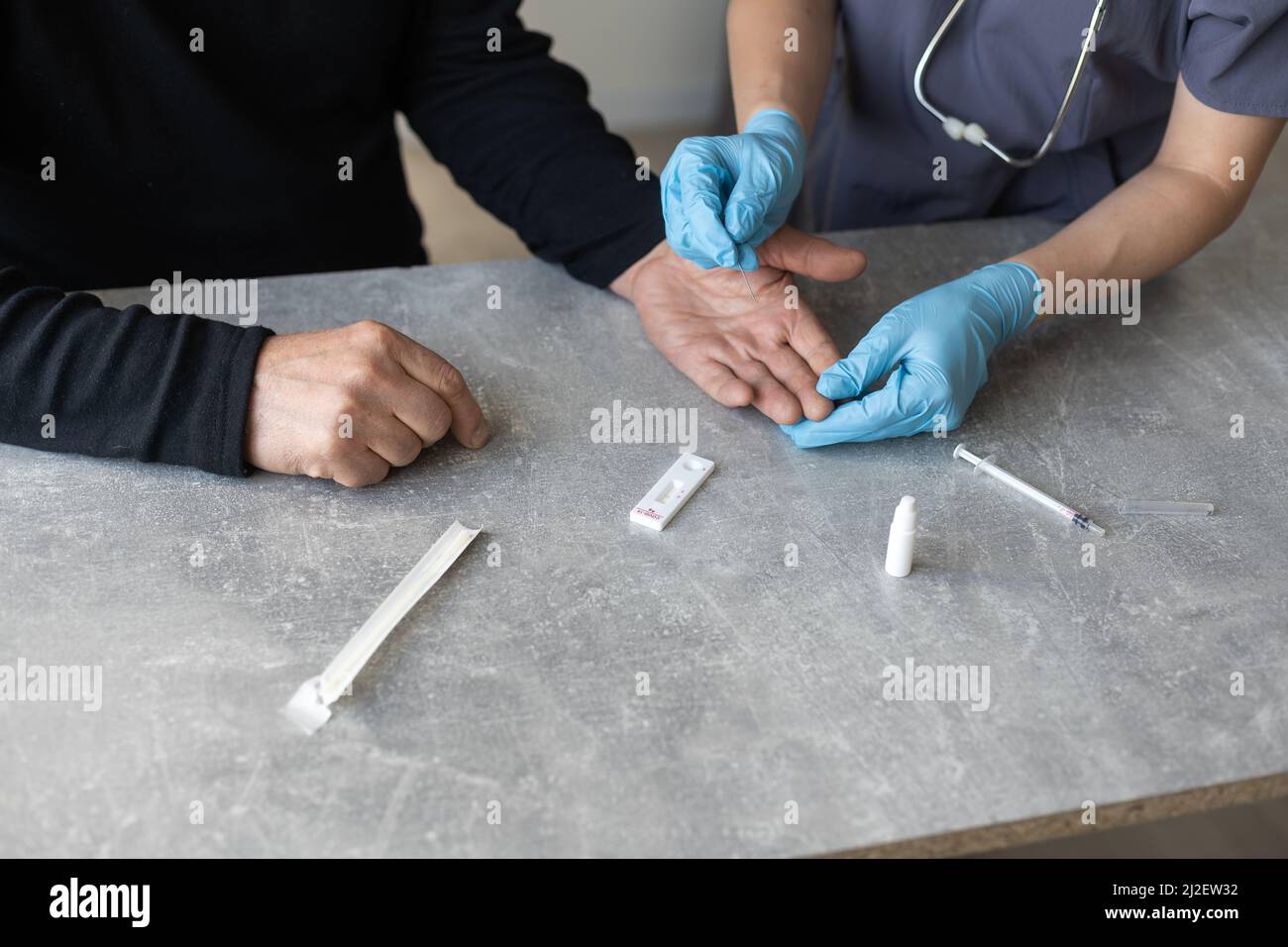 elderly man and nurse covid blood test Stock Photo - Alamy