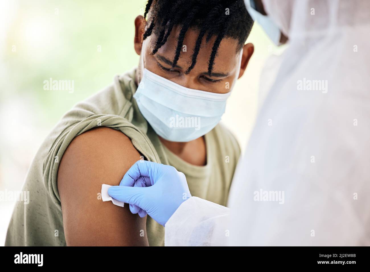 Cleaning the injection site. Cropped shot of an unrecognizable doctor ...