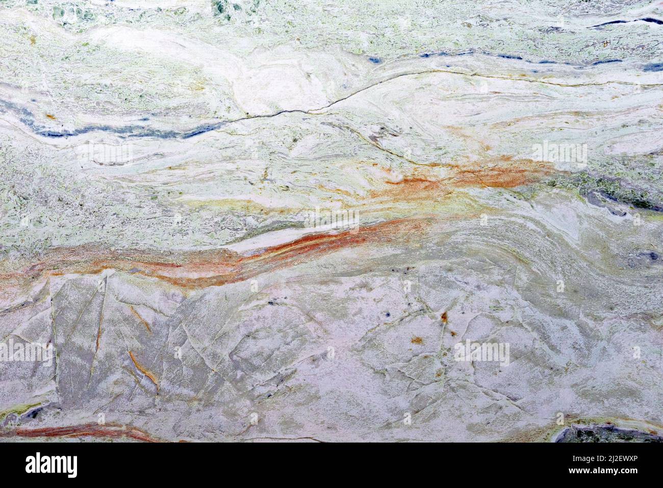 Texture of natural gray-green quartz stone with orange mineral ...