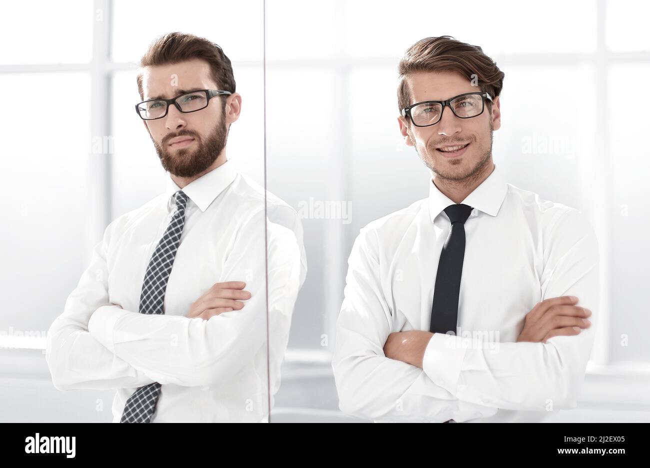 two serious business people standing in the office Stock Photo - Alamy