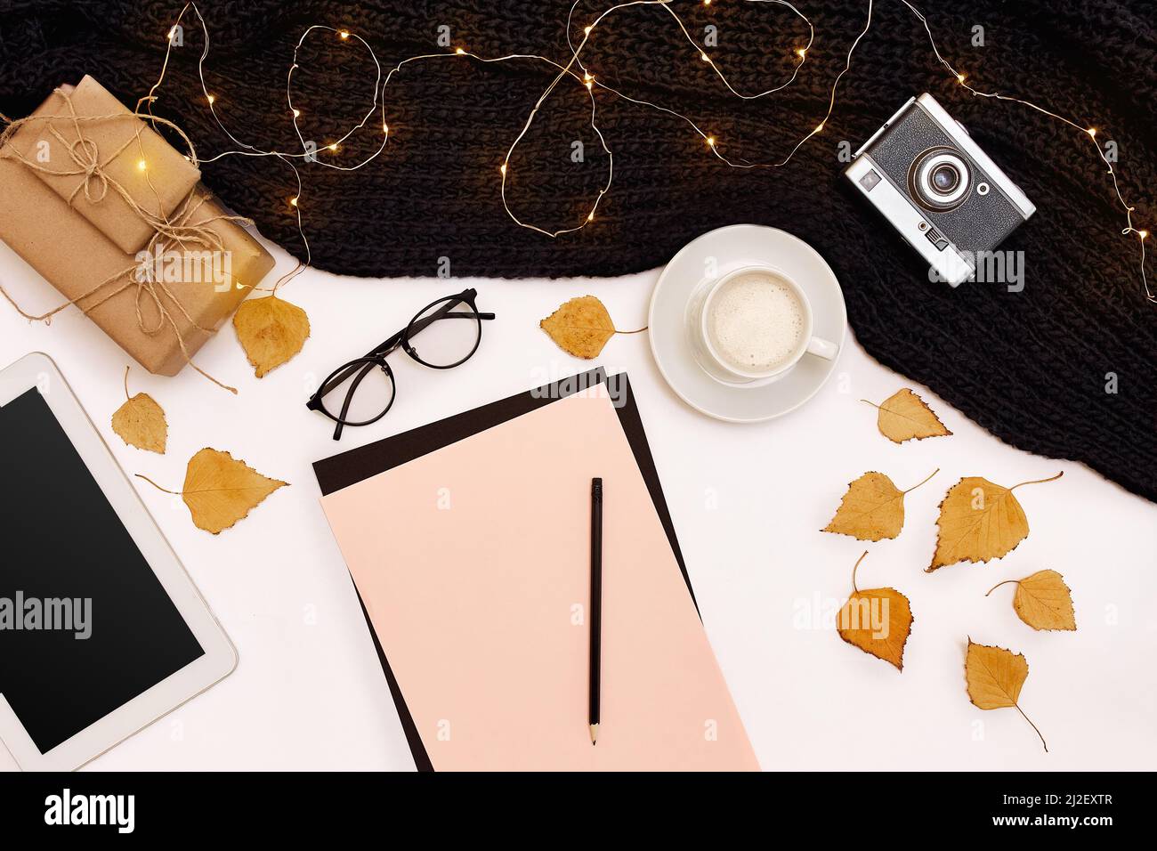 Romantic autumn mock up. Sheet of pink paper, yellow and orange leaves ...
