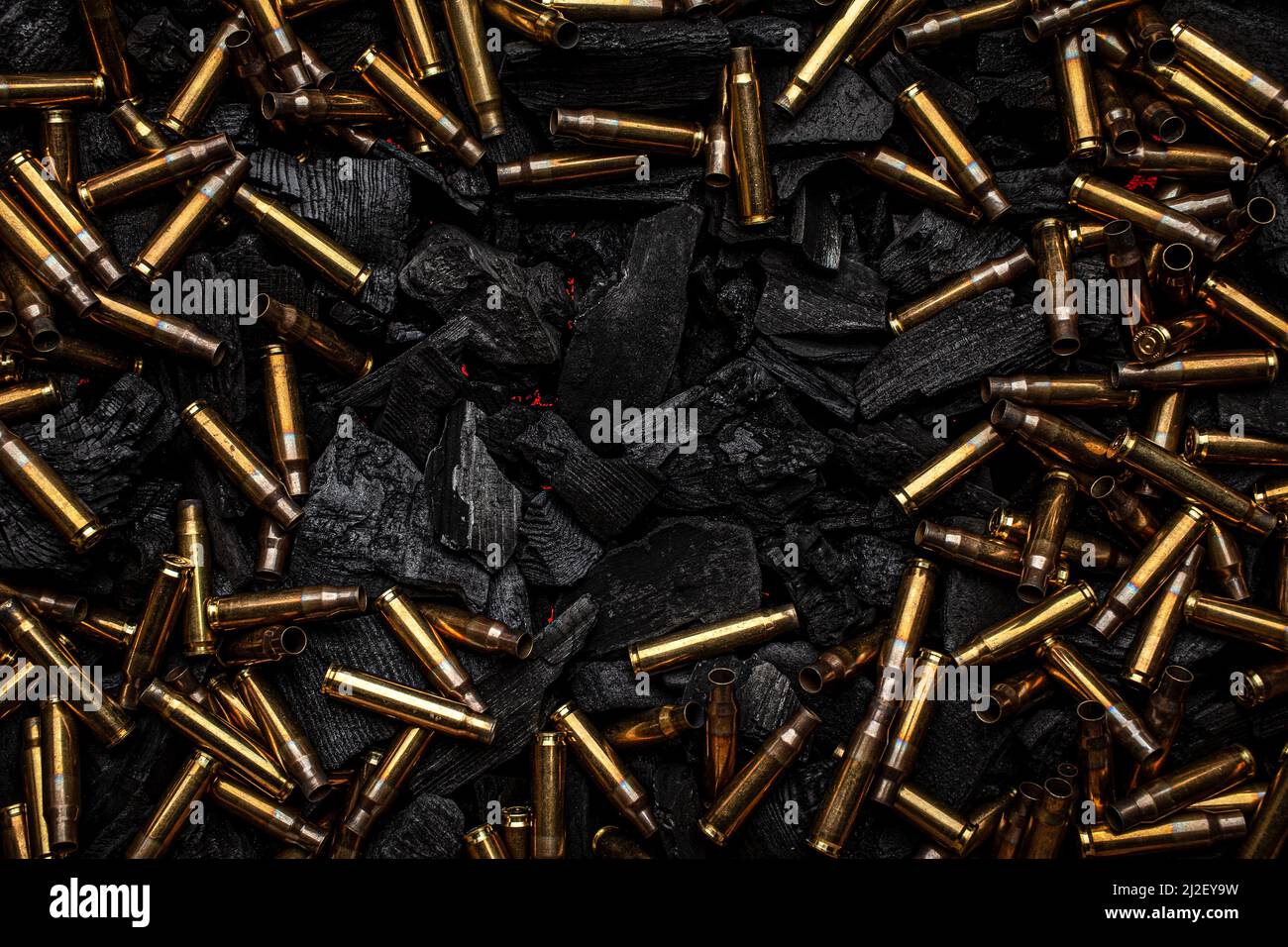 Empty shells from weapons on black smoldering coals. Consequences of ...