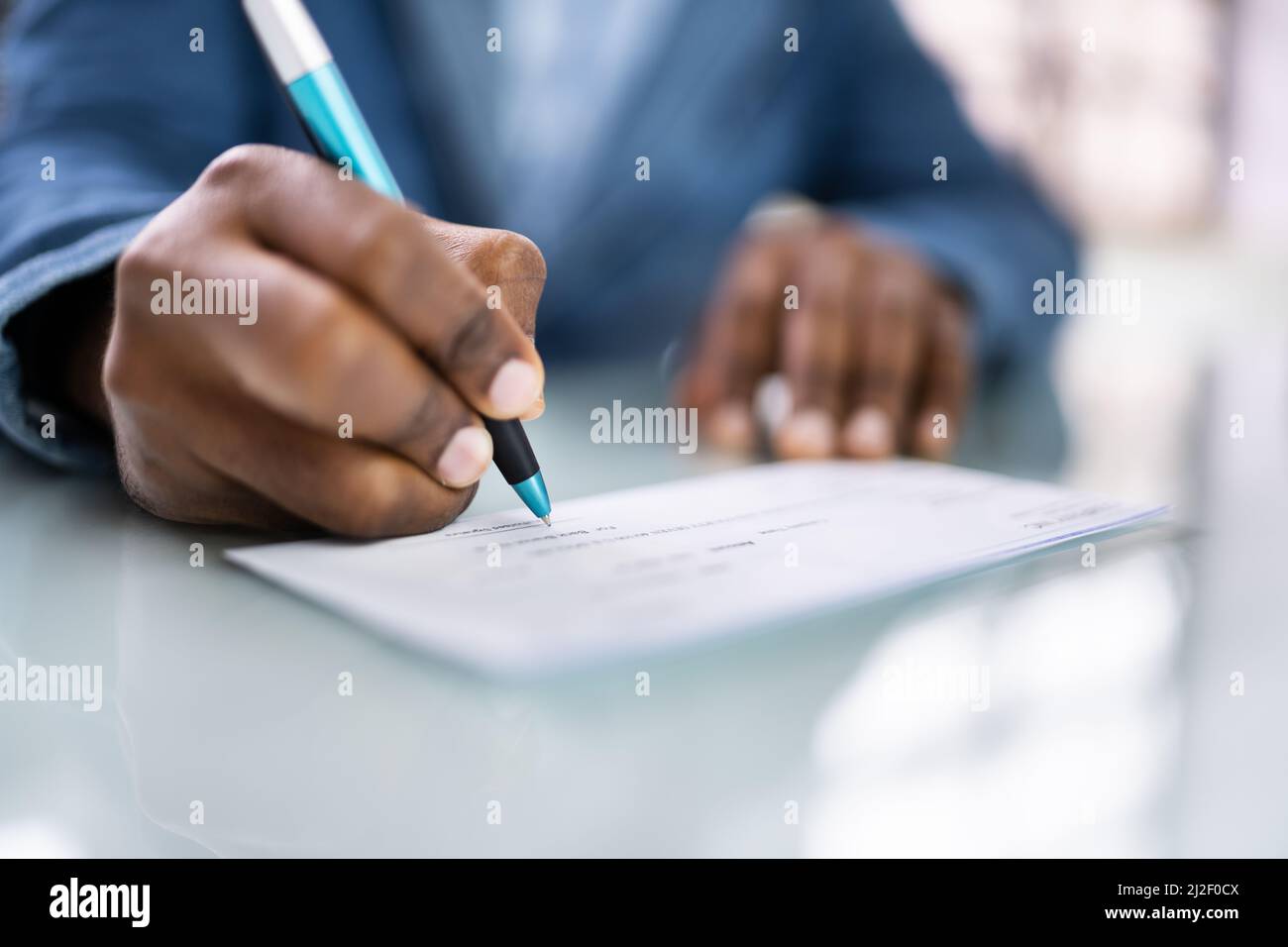 Hand writing cheque hi-res stock photography and images - Alamy