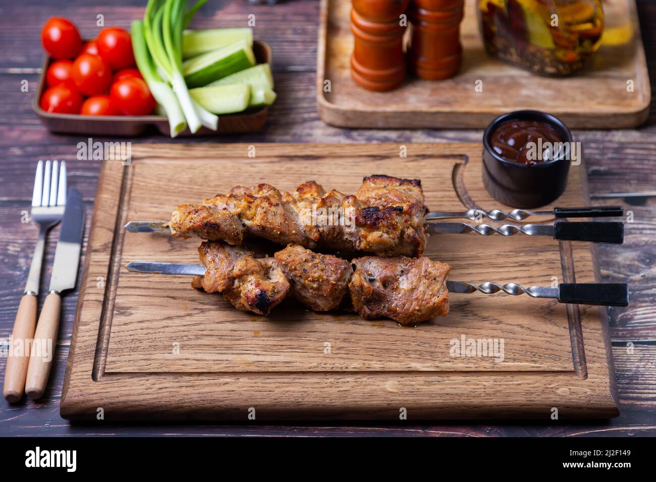 Traditional Russian shashlik on skewers with vegetables. Grilled pork ...