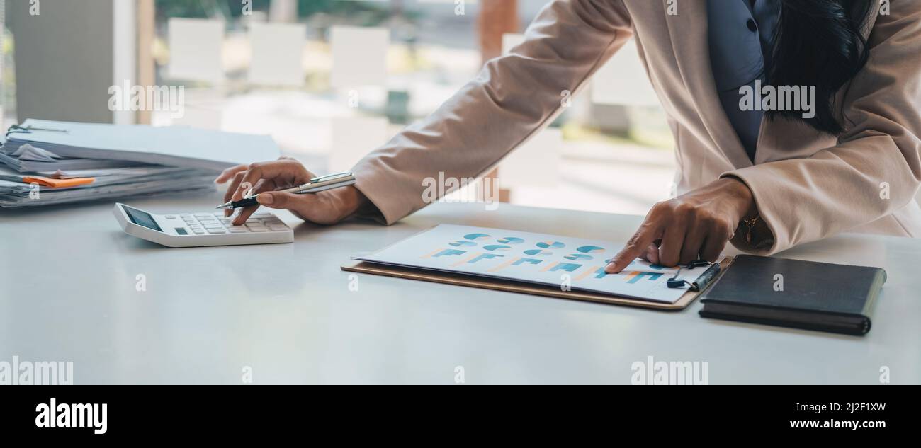 Accountant working on calculator to calculate business data concept ...
