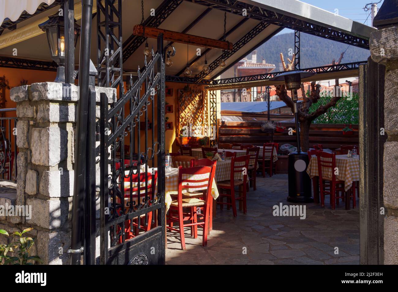 Vytina, Greece empty tavern courtyard with chairs and tables in Arcadia ...