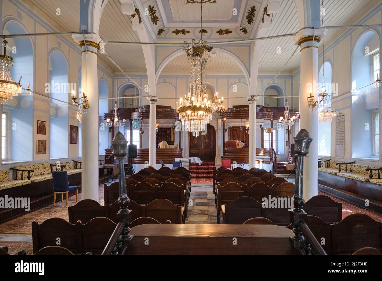 Interior view of the space with the bima and torah along the back wall ...