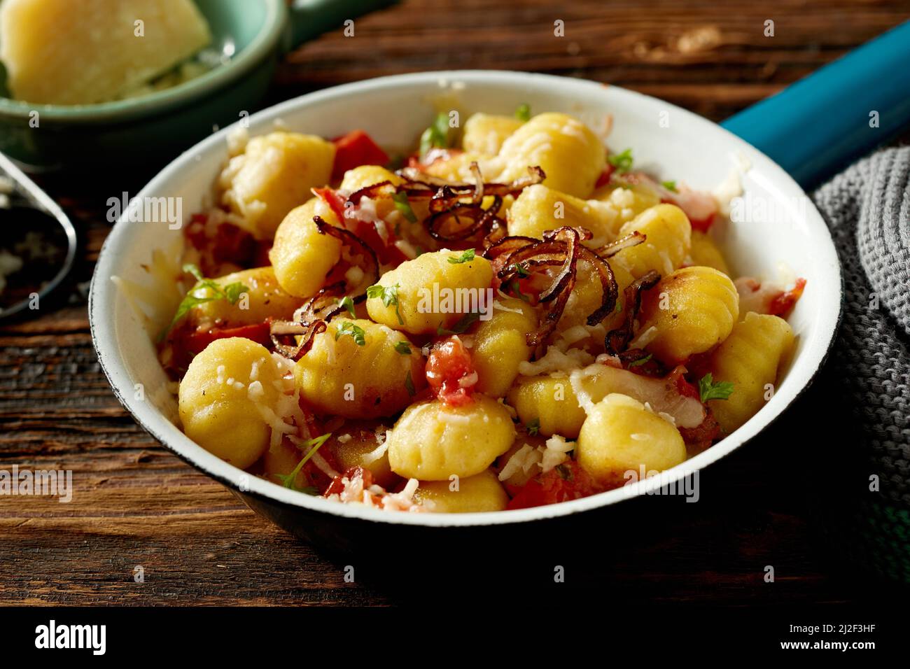 The appetizing traditional Italian potato gnocchi served with stewed ...