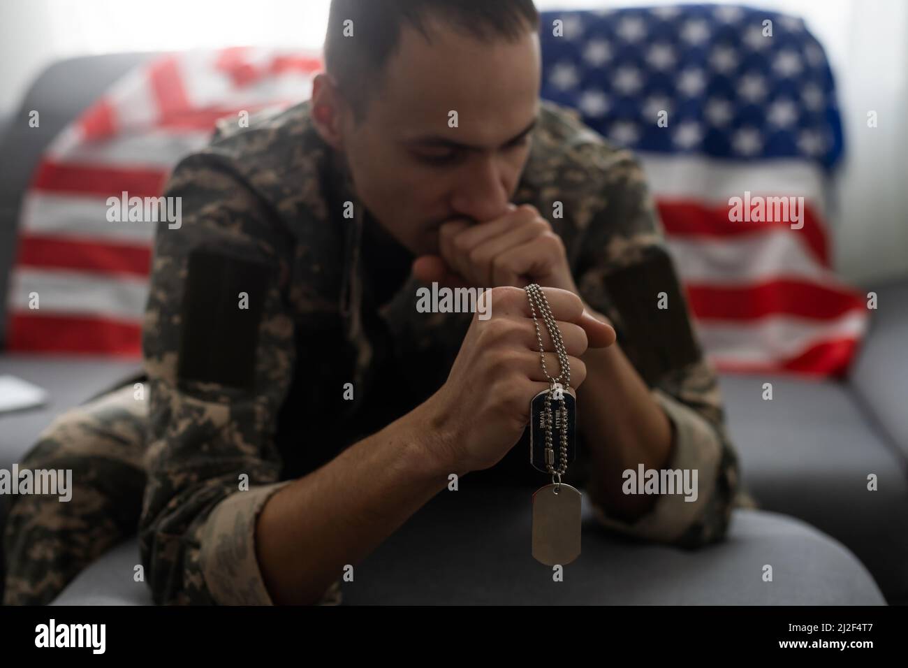 Sad man with USA flag at home. Memorial Day celebration Stock Photo - Alamy