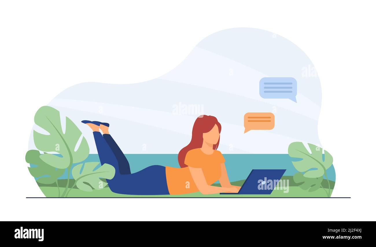 Woman chatting on laptop and lying on meadow. Computer, online, network ...