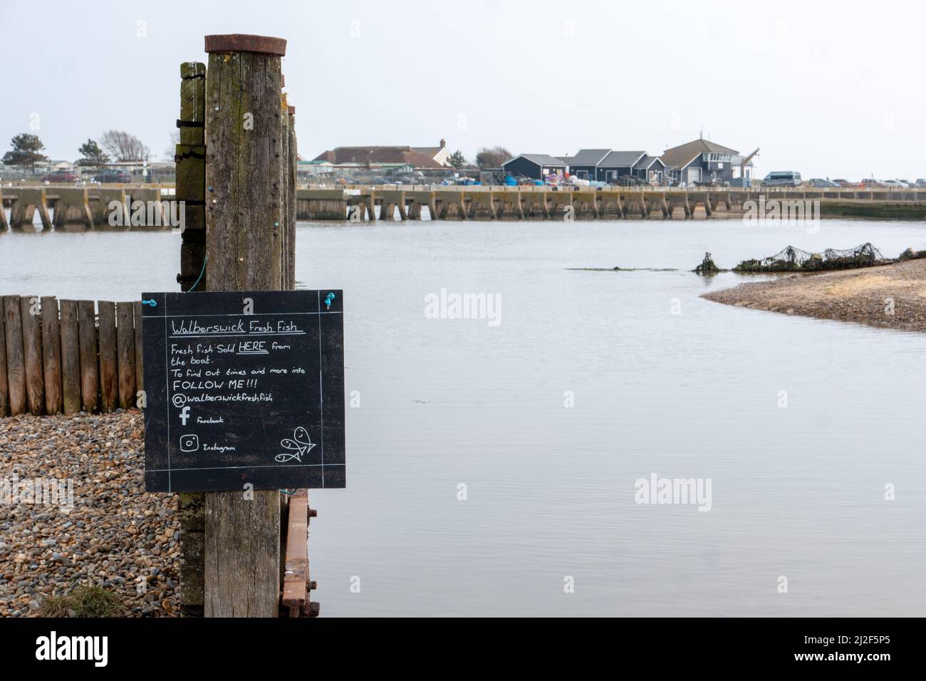Fresh Fish for sale blackboard sign, fixed to a wooden pier post, at ...