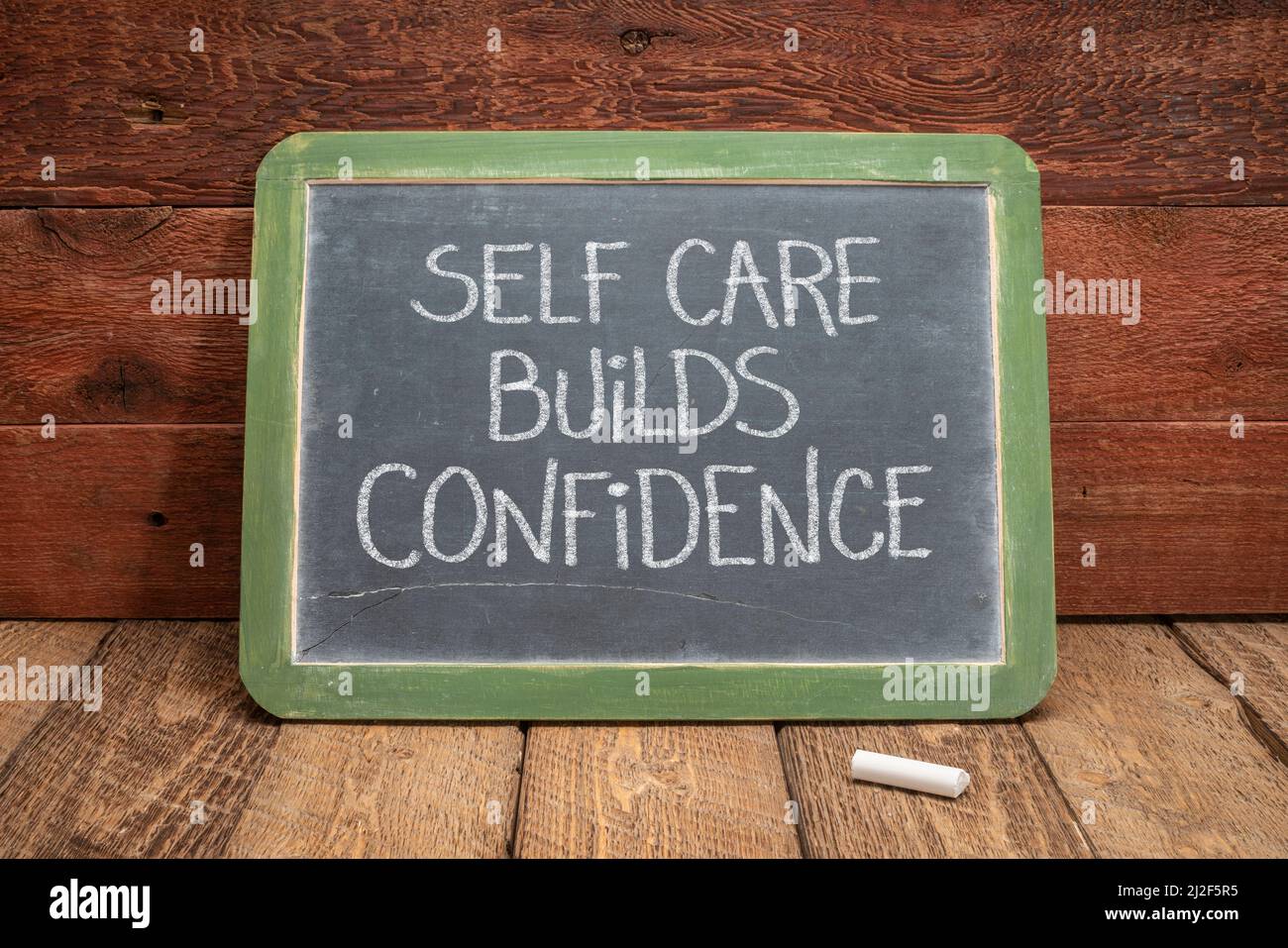 self care builds confidence, white chalk handwriting on a vintage slate ...