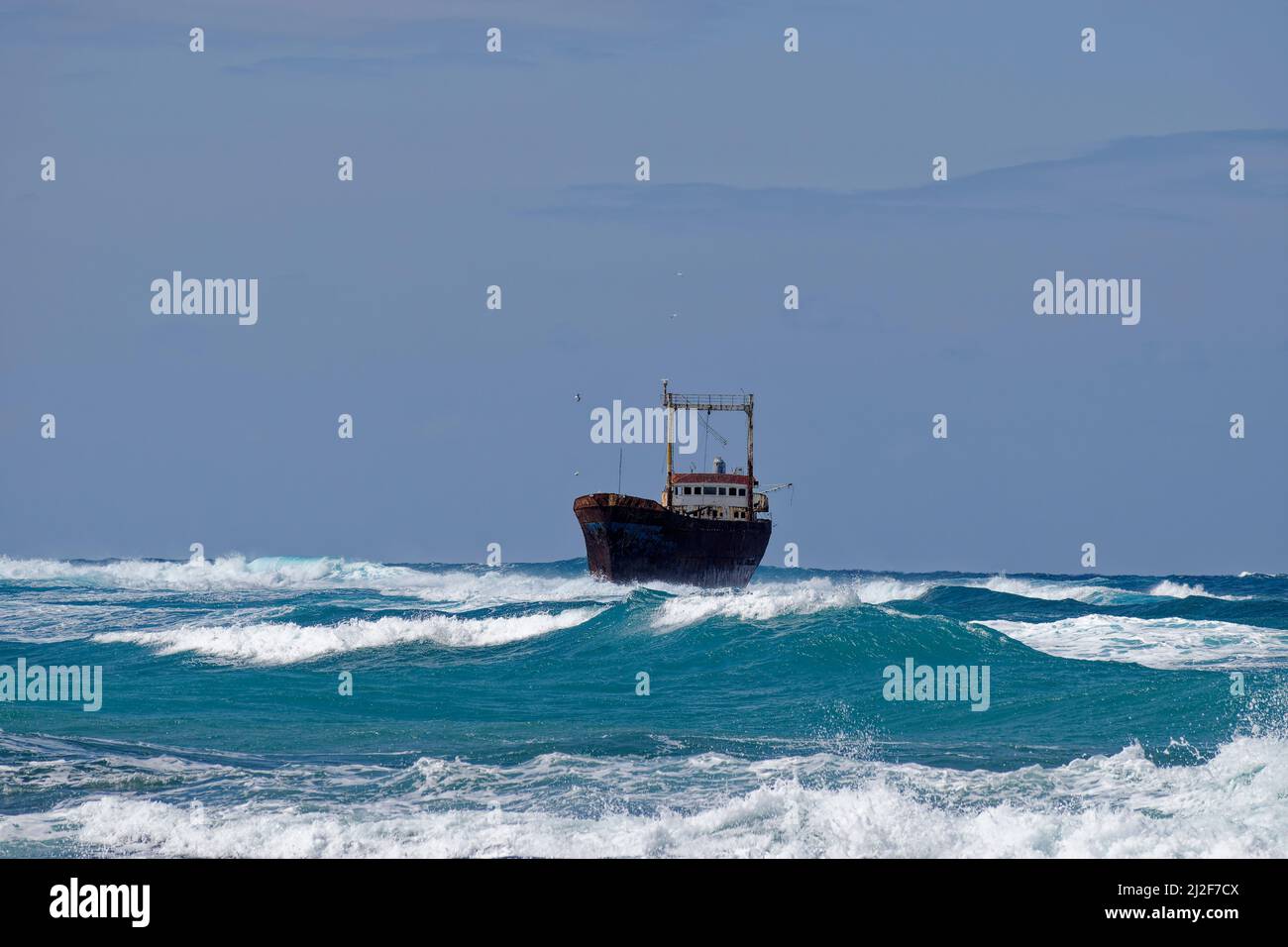 Shipwreck grounded on coastal reef Stock Photo - Alamy