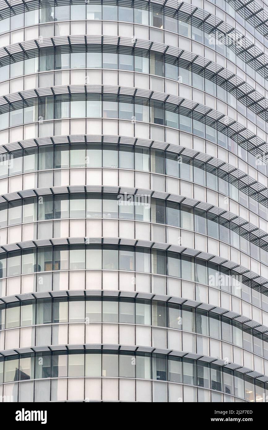 A vertical shot of a modern glass-walled building in a city Stock Photo ...