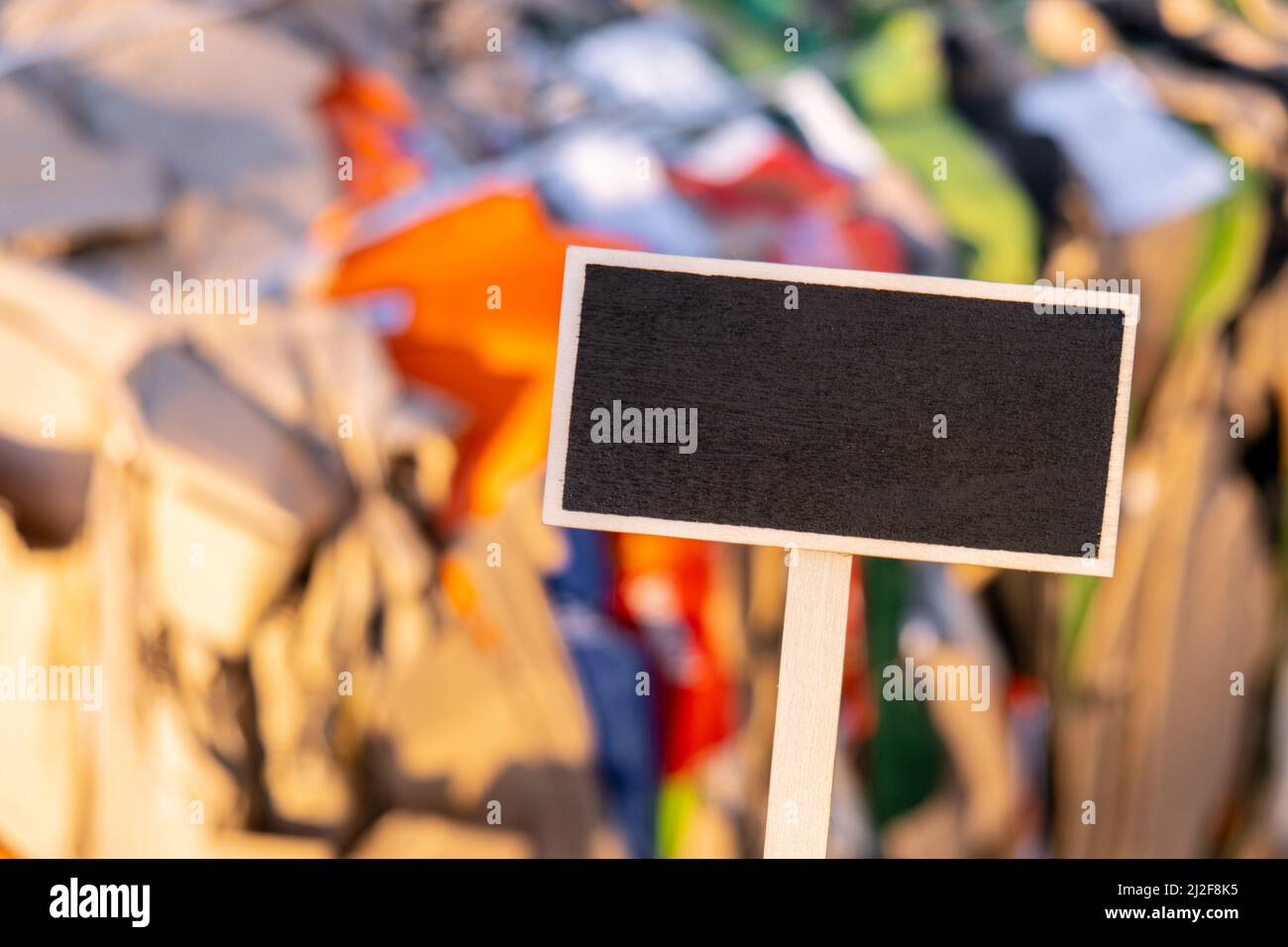 Wooden information label sign with black chalkboard against defocused ...