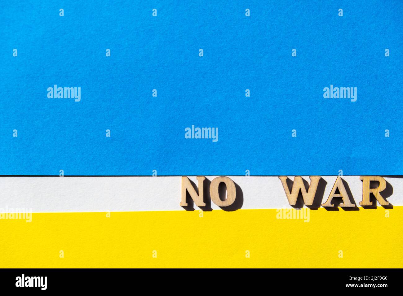 Ukrainian national flag made of paper. No war text. Stop War. The ...
