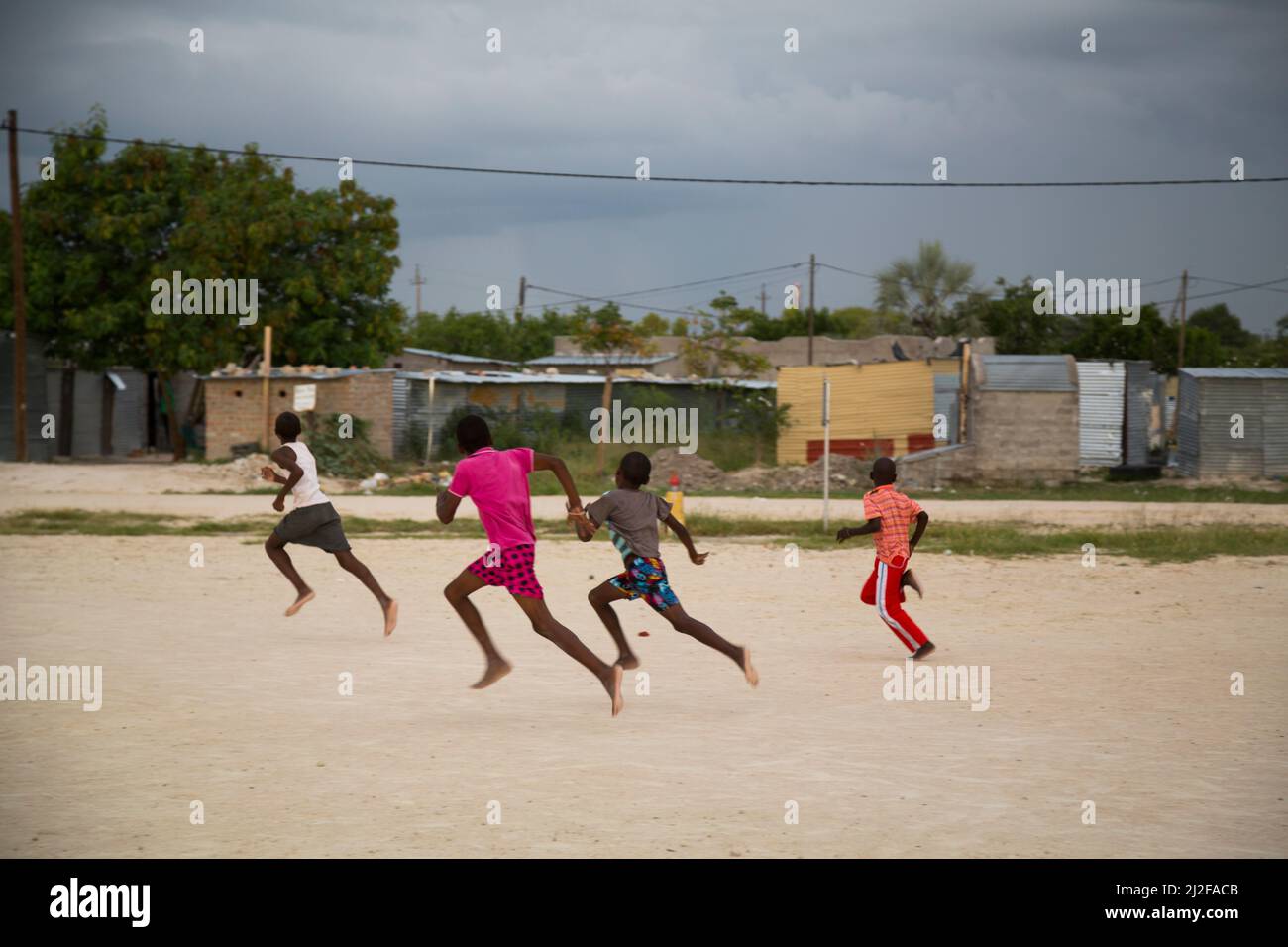 Kid playing soccer in africa hi-res stock photography and images - Alamy