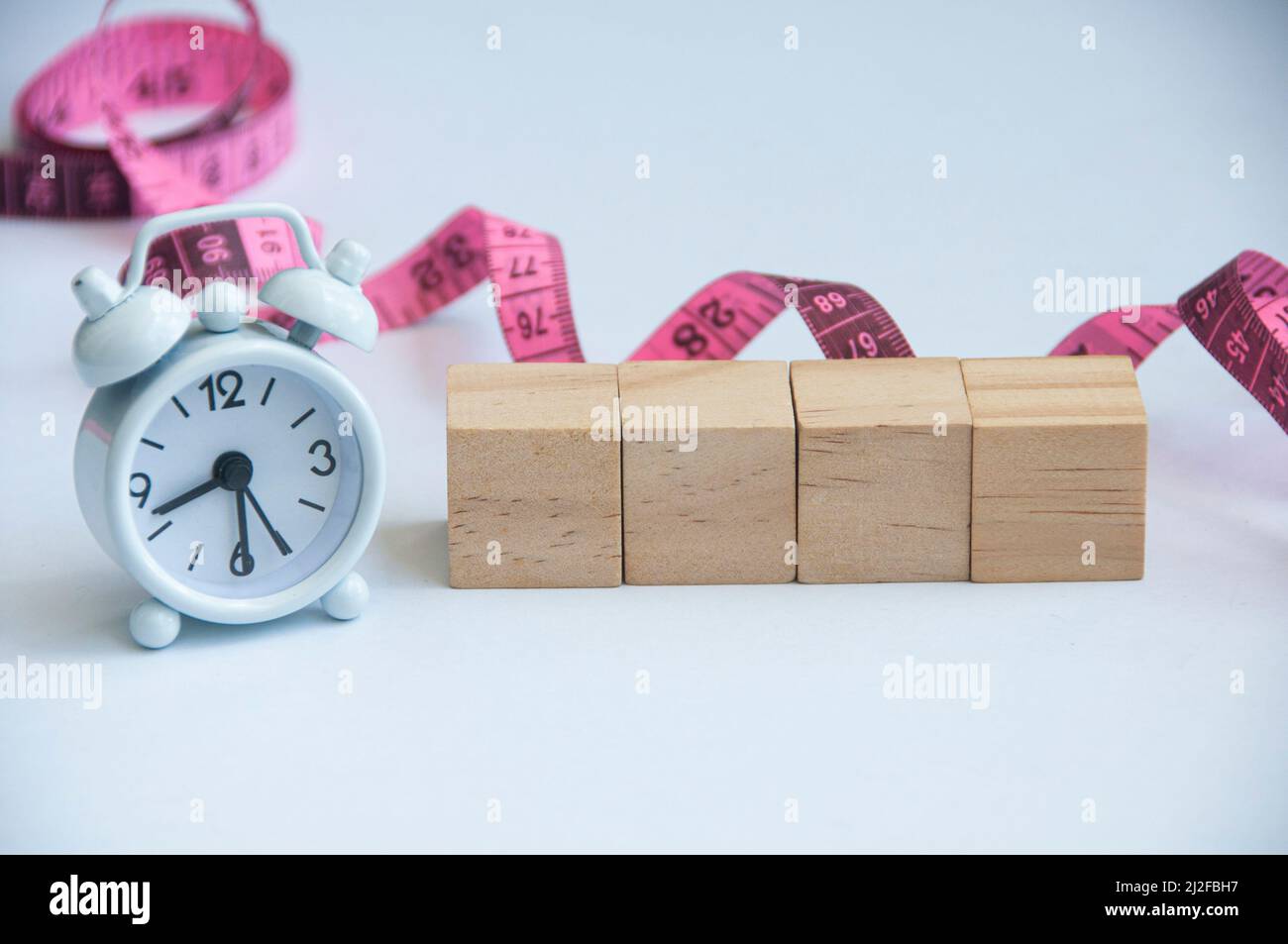 Alarm clock measuring tape wooden table hi-res stock photography and ...