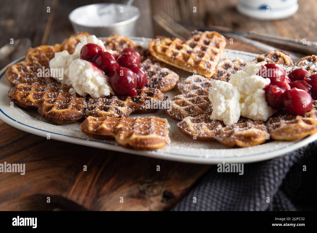 Homemade heart shaped waffles with whipped cream and sour cherry ...