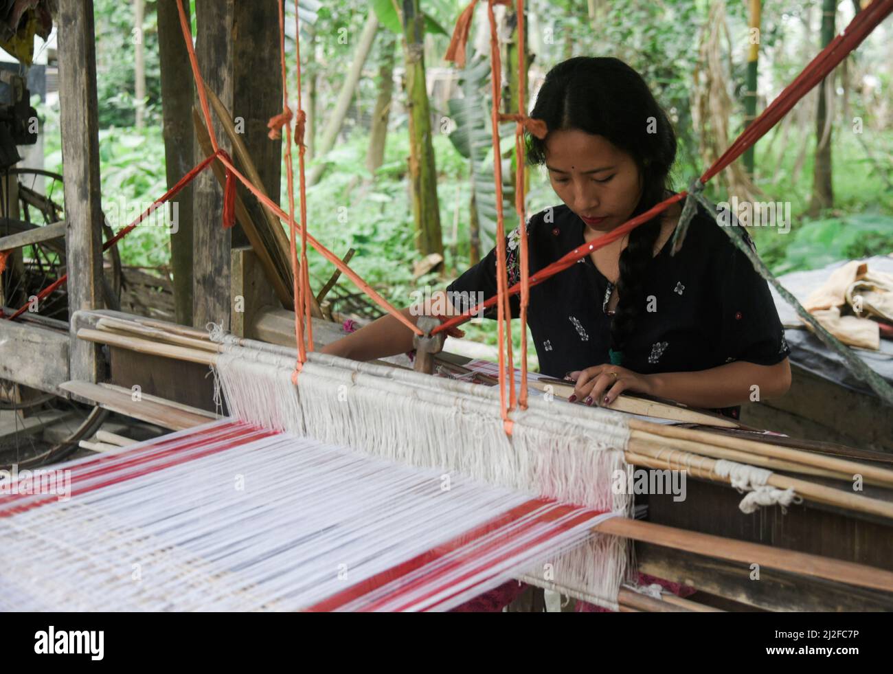 March 31, 2022, Morigaon, India: An Assamese woman weaves Assamese ...