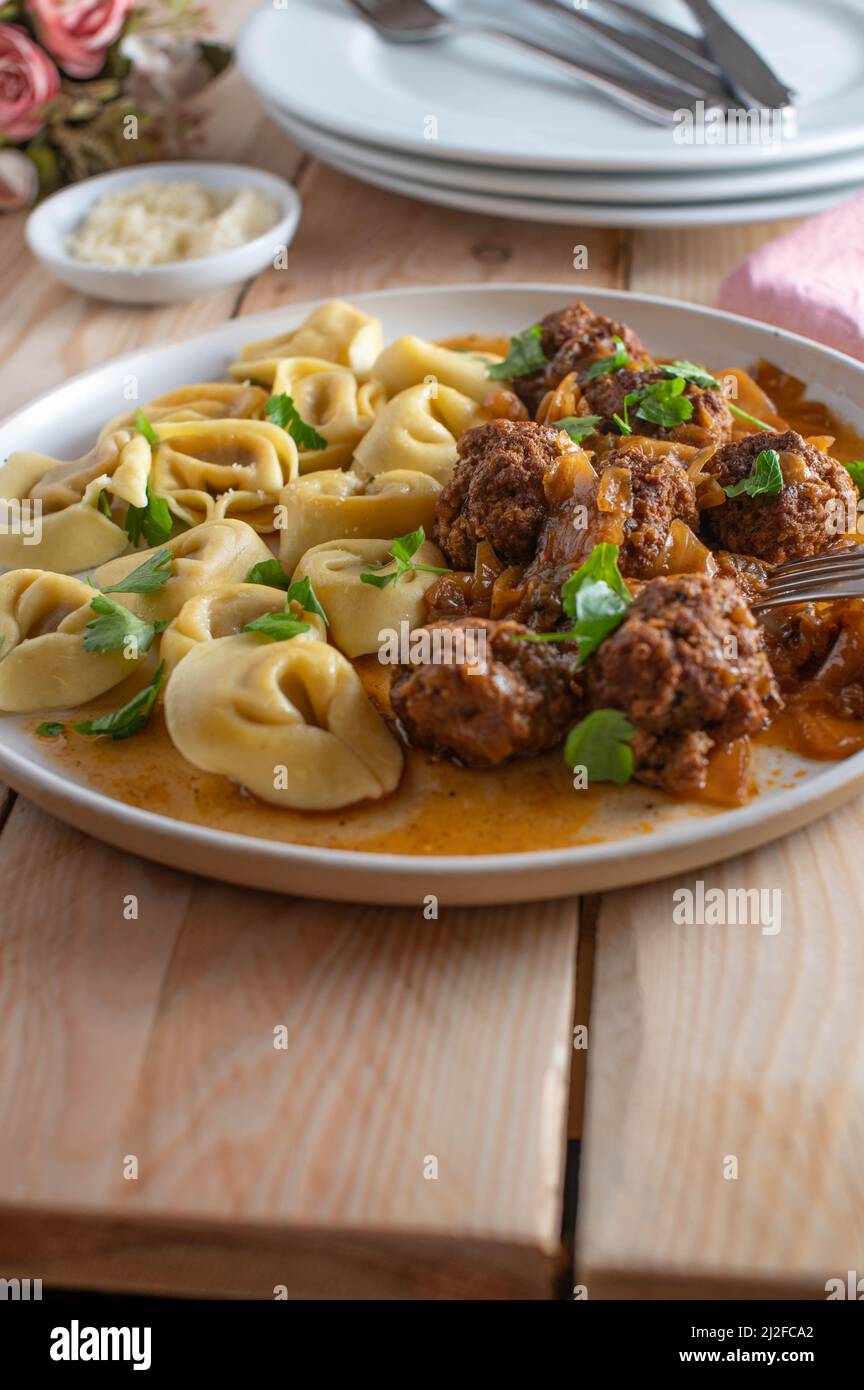 Rustic pasta dish with meatballs, cabbage and sauce. Cooked with fresh ...