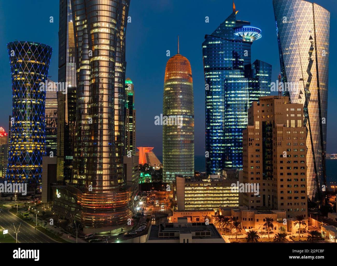 Doha, Qatar- March 03,2022 : Qatar skyline during sunset with colorful ...