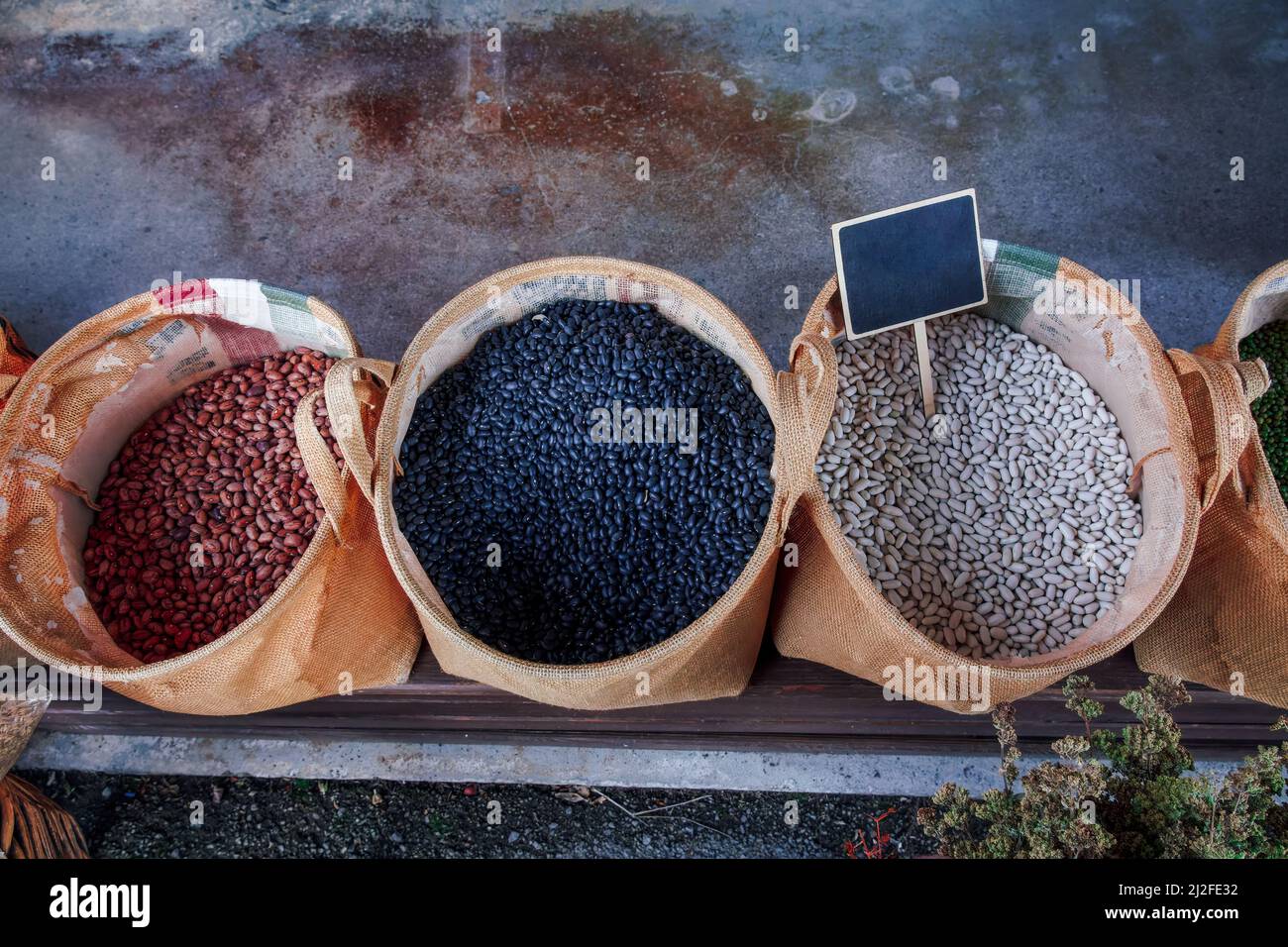 Bags full of various dried beans on a Greek store exterior display in ...