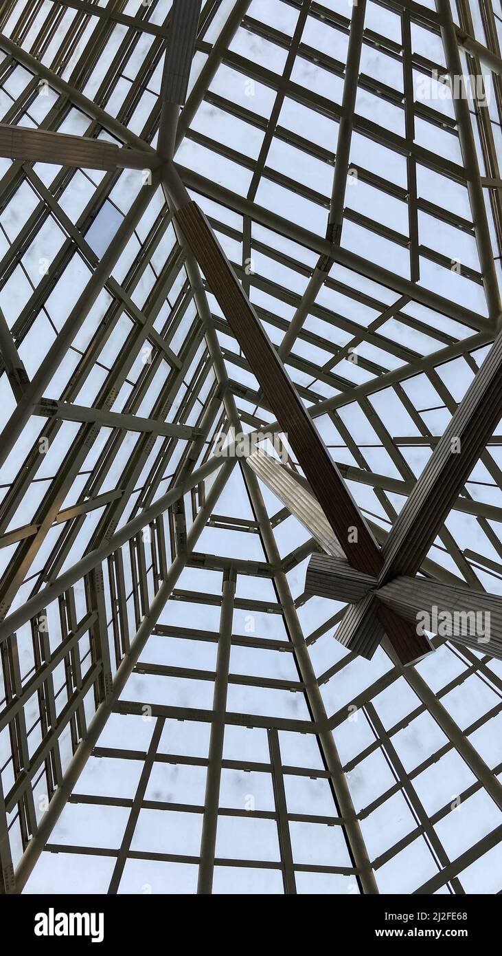 A vertical shot of building architecture details on a blue sky ...