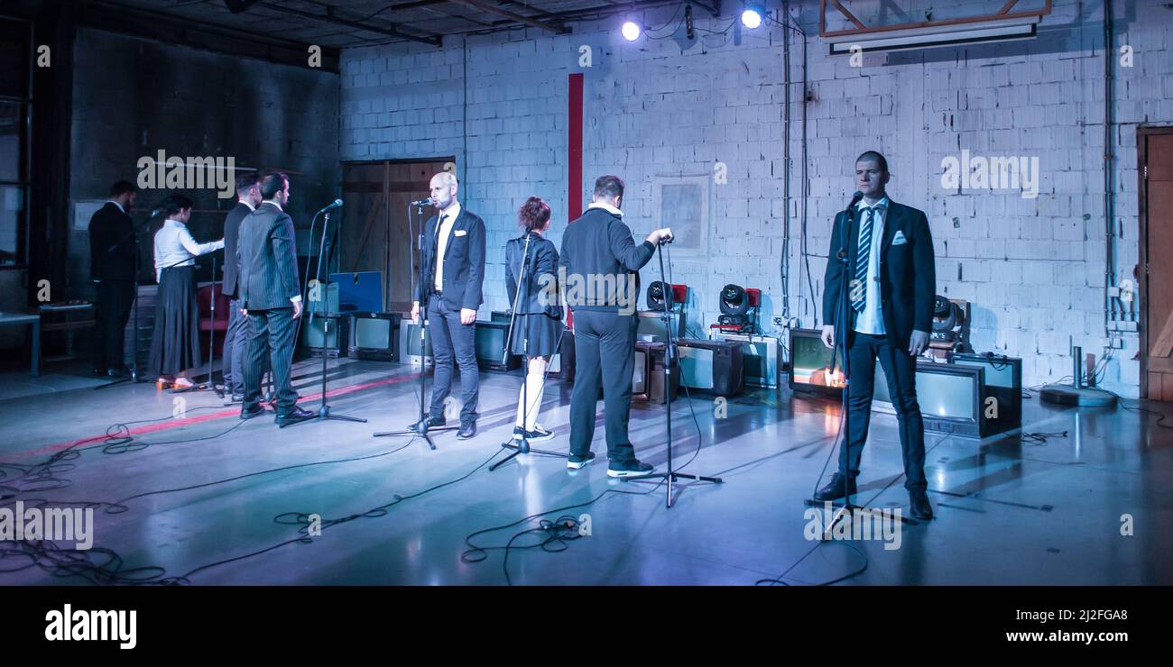 Large group of theater actor artists on stage perform play for audience ...