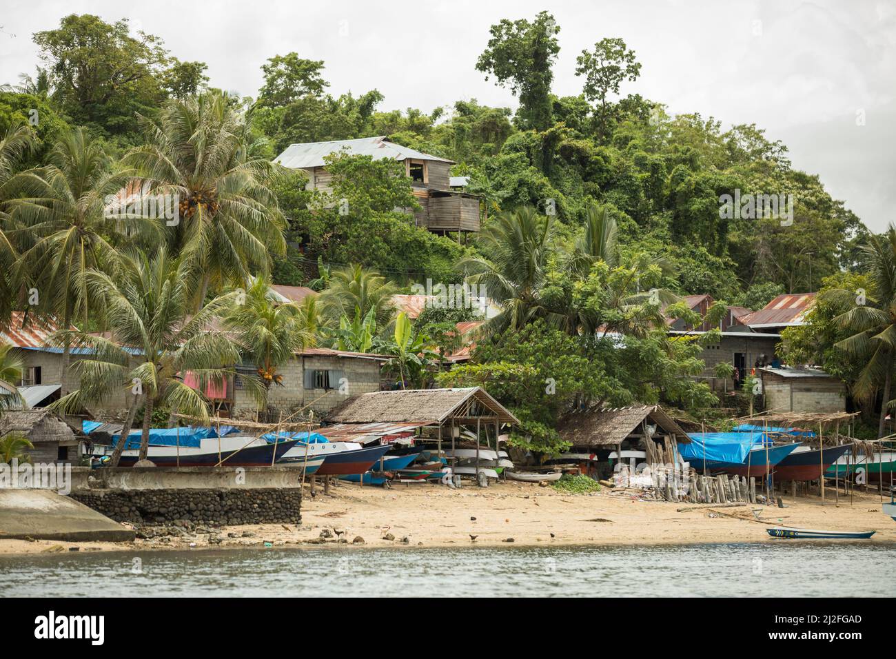 Coastline and fishing village on the small, rural island of Karampuong ...