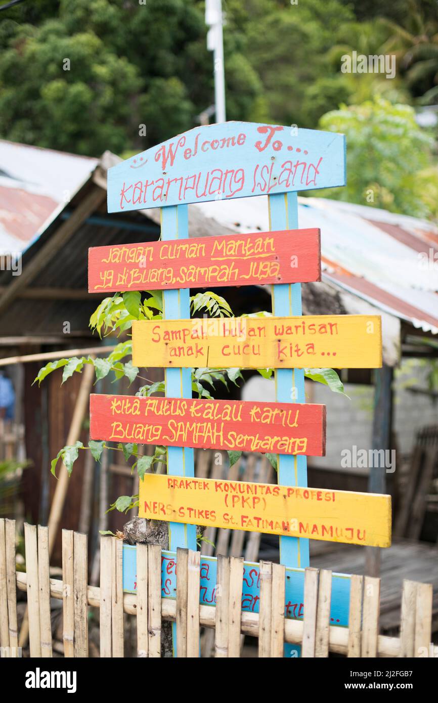 A sign reads "Welcome to Karampuang Island," as you disembark from the ...
