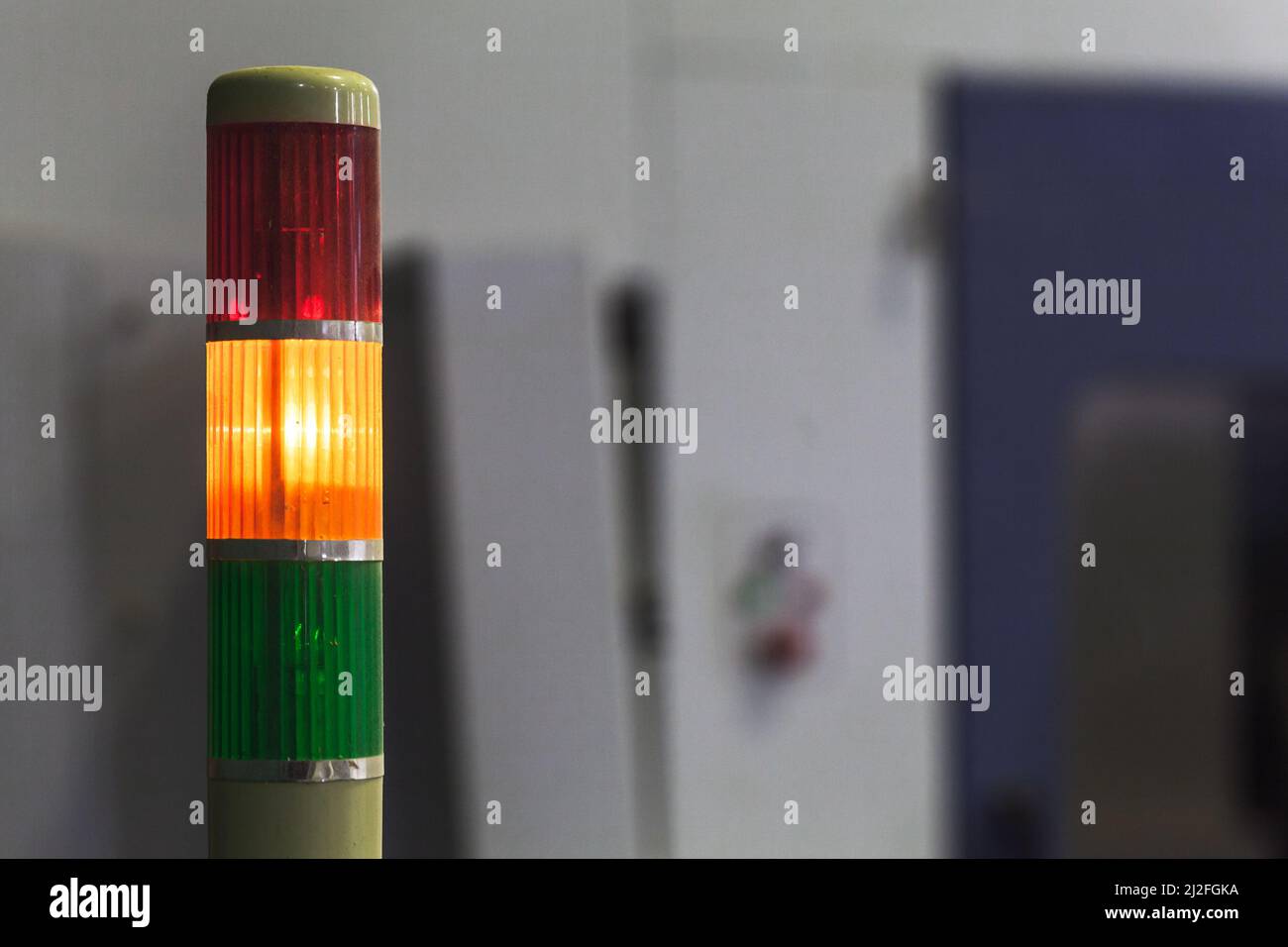 Industrial working lights indicator of a cnc machine shows yellow ...