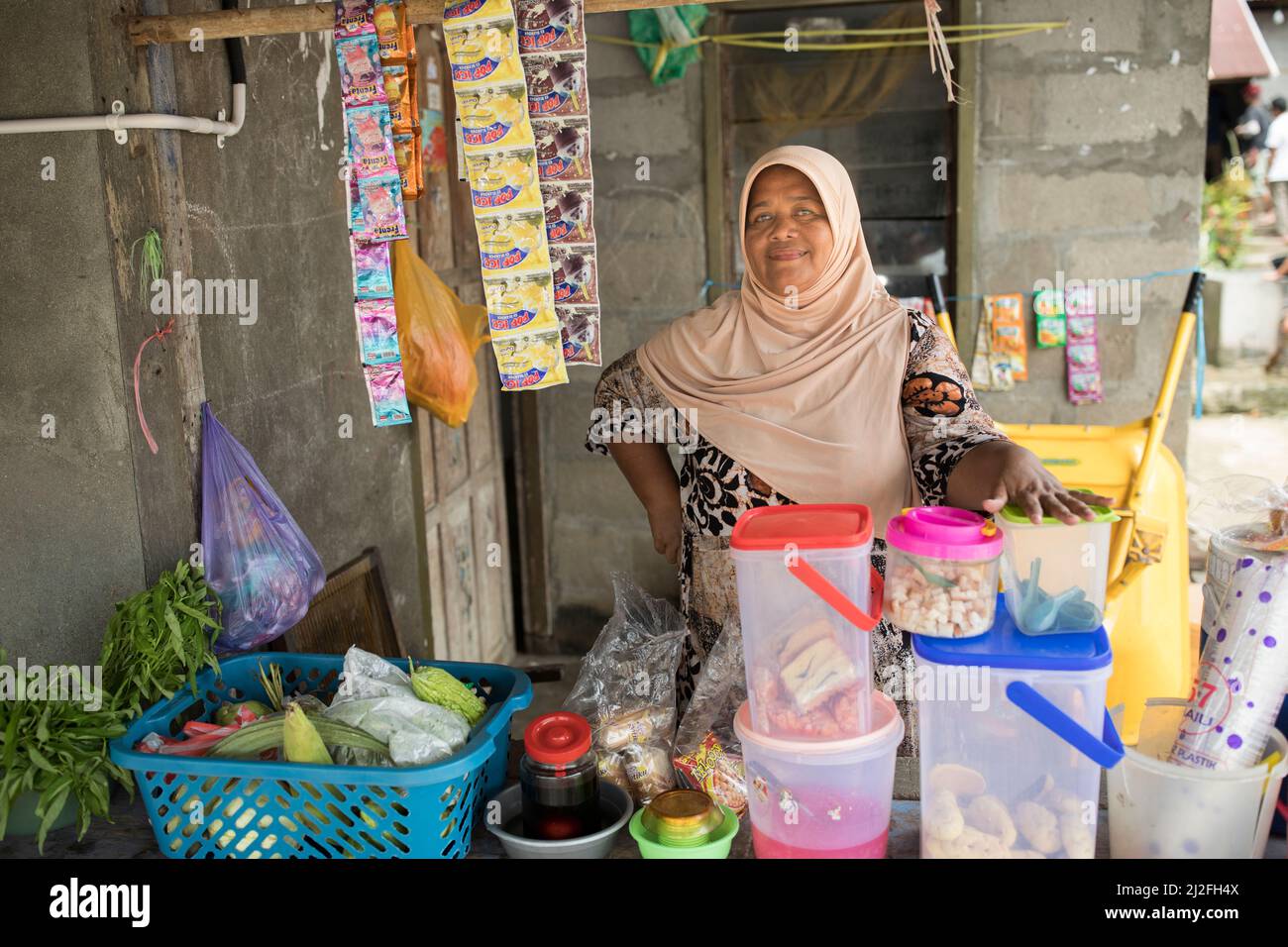 Portrait of a small shop owner on Karampuang Island off the coast of ...