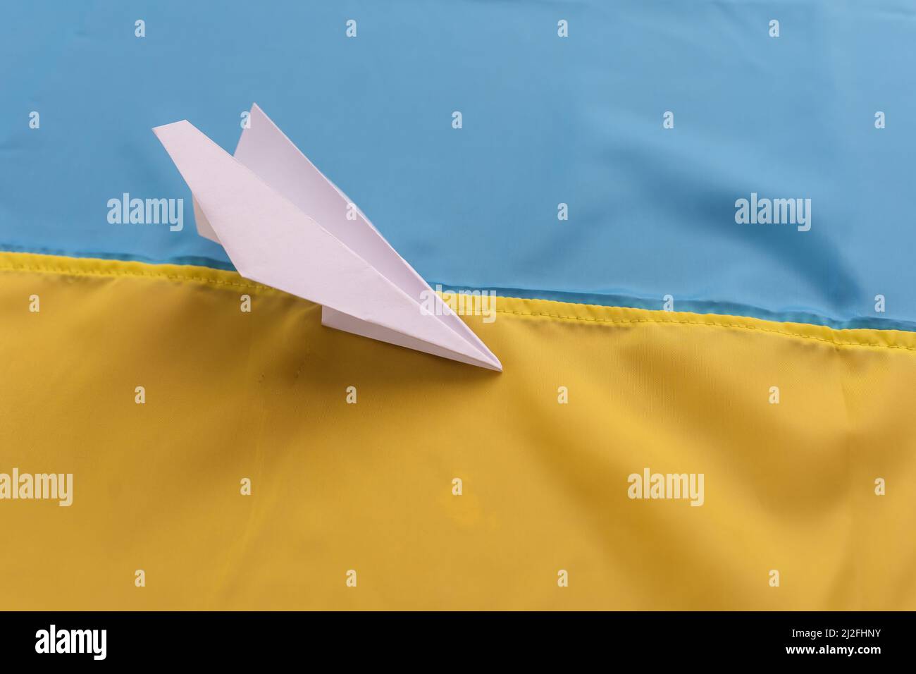 paper airplane on the background flag of Ukraine, flags of the country ...