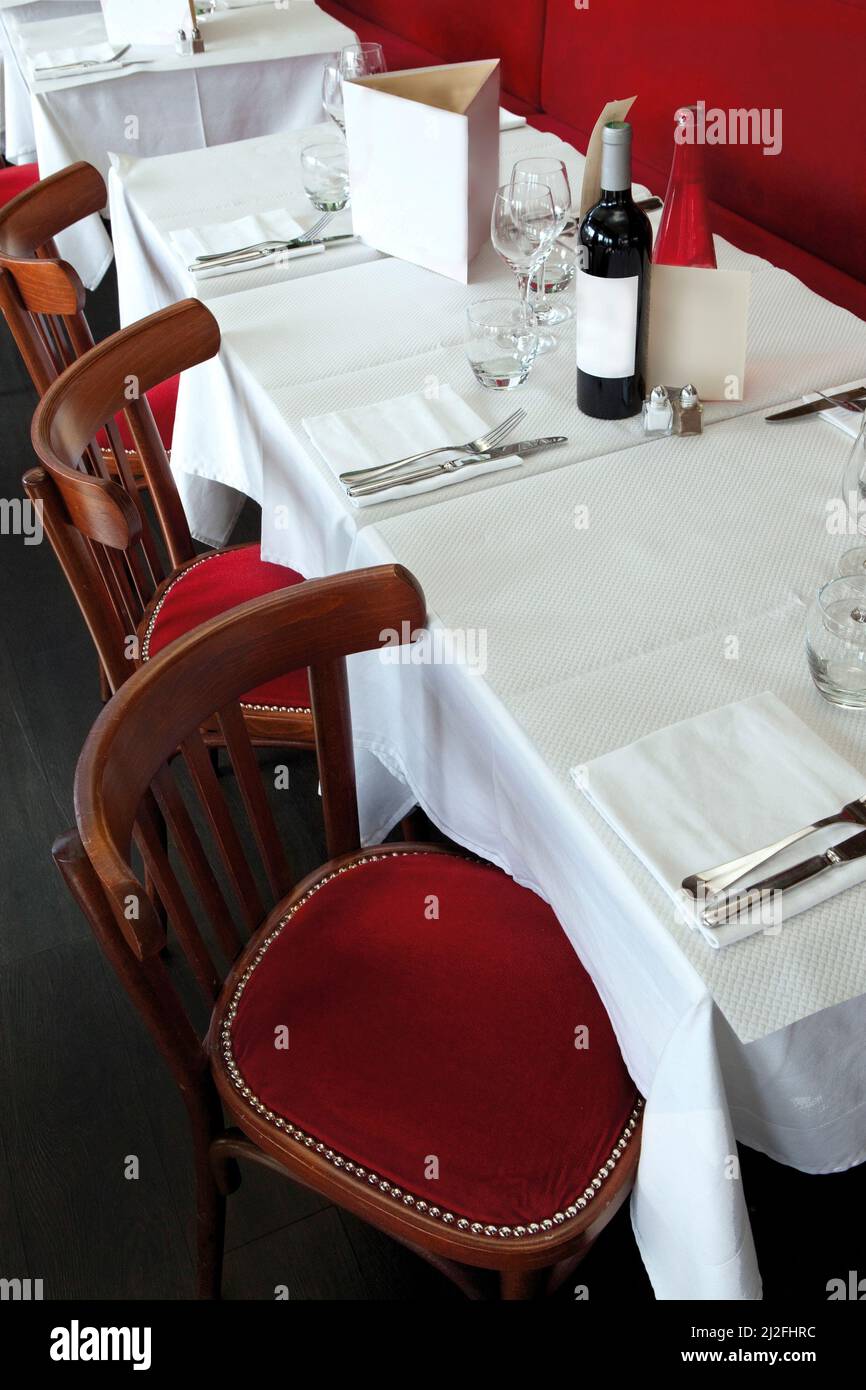 Red velvet chairs and table set in a vintage restaurant Stock Photo - Alamy