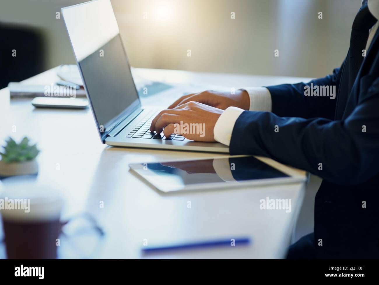 Working hard and working smart. Shot of an unrecognisable businessman ...