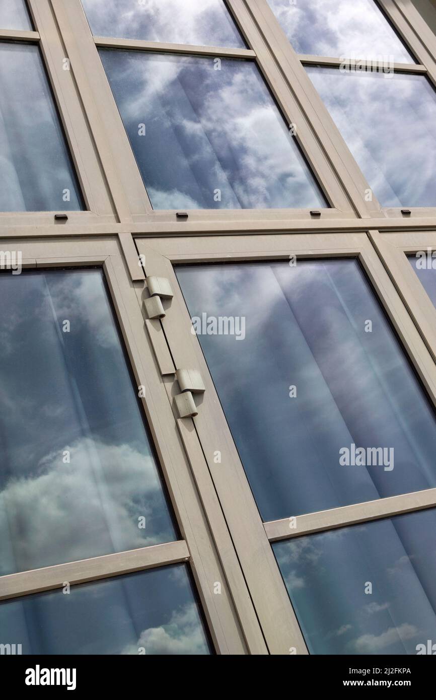Aluminum windows and cloudy sky on background Stock Photo - Alamy