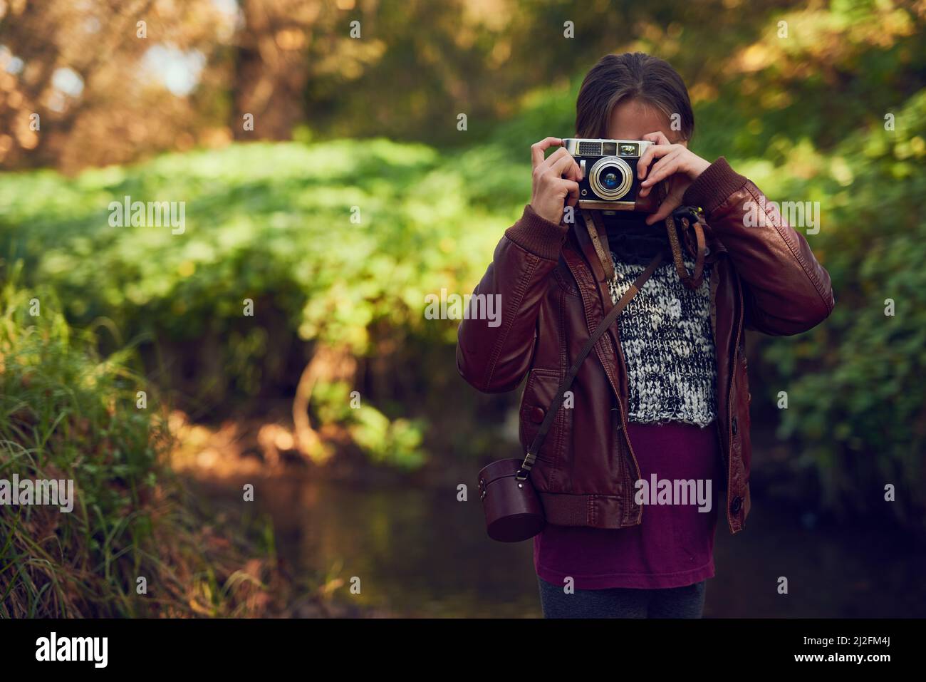 Looking at the world through a different lens. Shot of a young girl ...