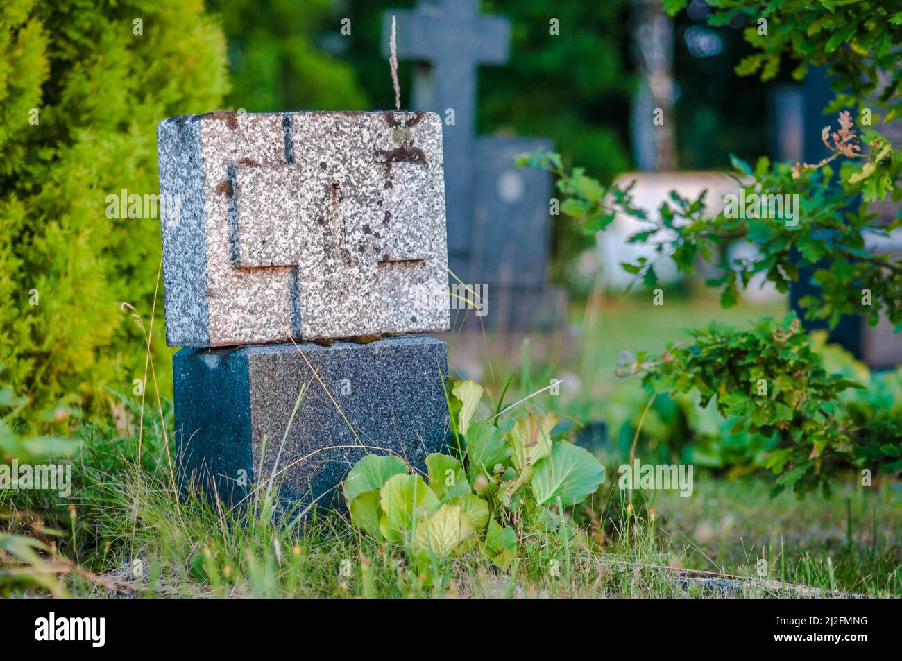 The close-up shot of a Christian gravestone with a cross sign Stock ...