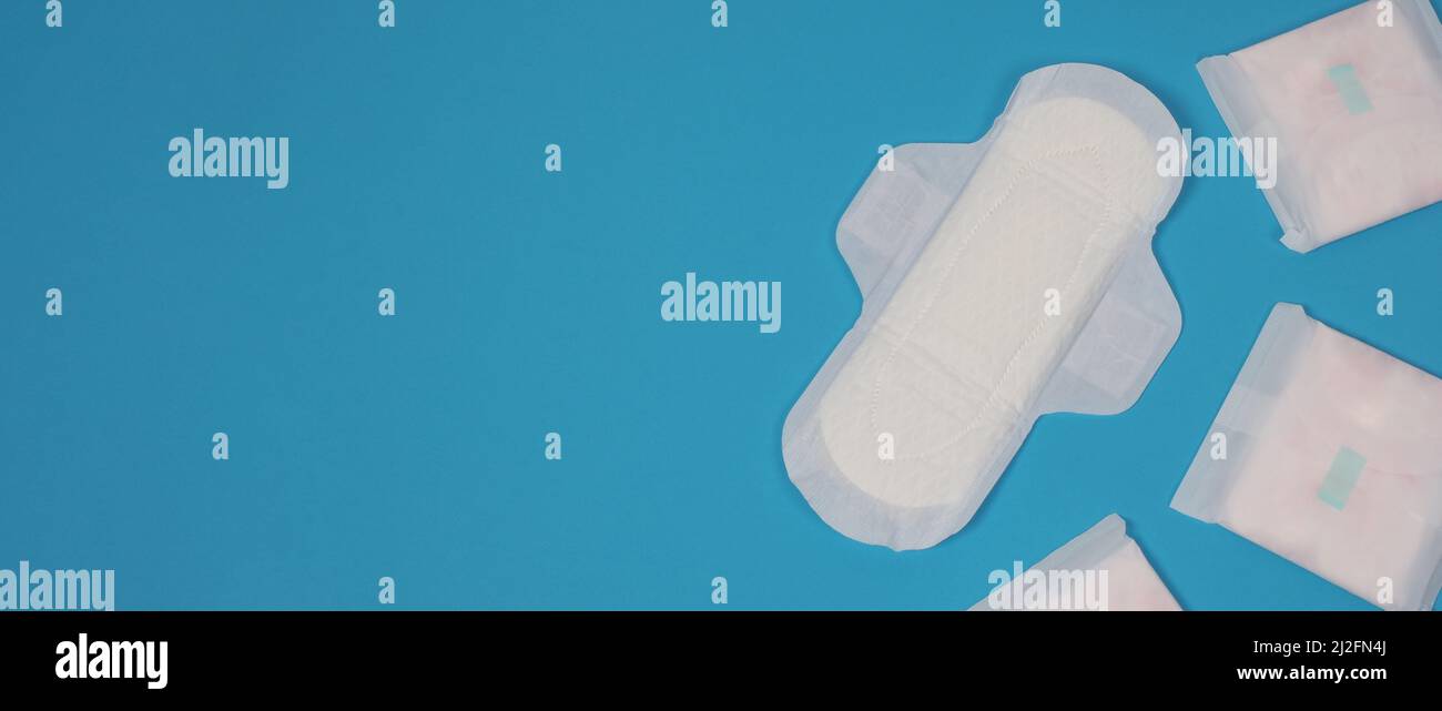 Woman sanitary napkins on blue background. Top view. Absorbent pads ...