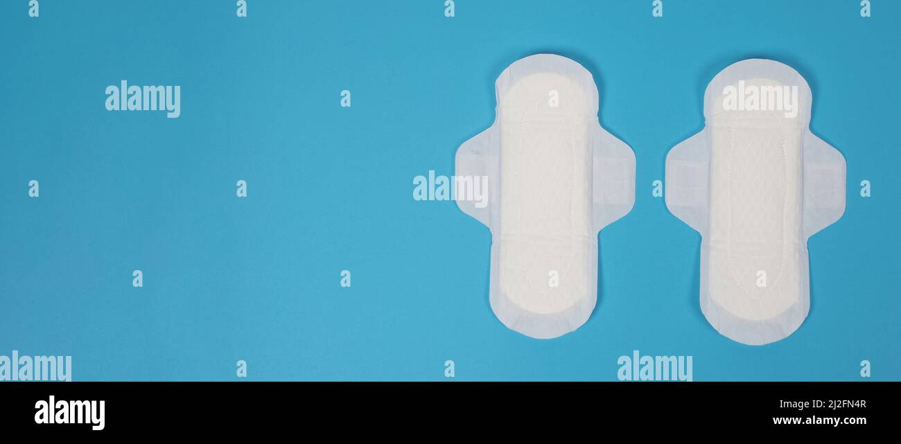 Woman sanitary napkins on blue background. Top view. Absorbent pads ...