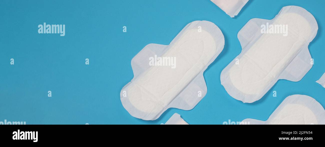 Woman sanitary napkins on blue background. Top view. Absorbent pads ...