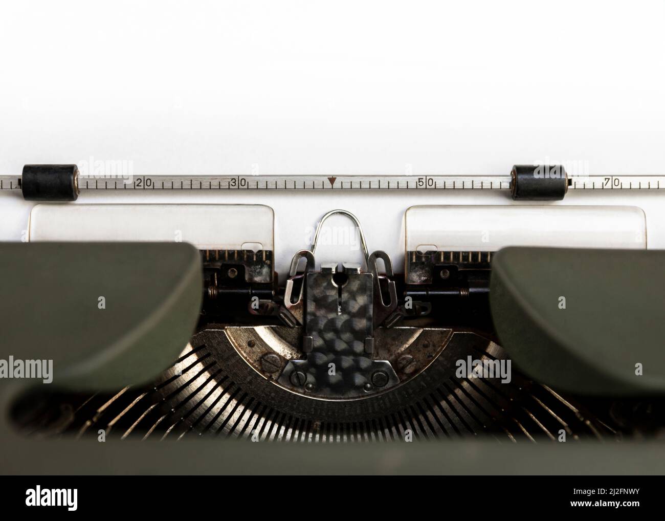 Vintage typewriter closeup. Blank paper sheet for copy space or add ...