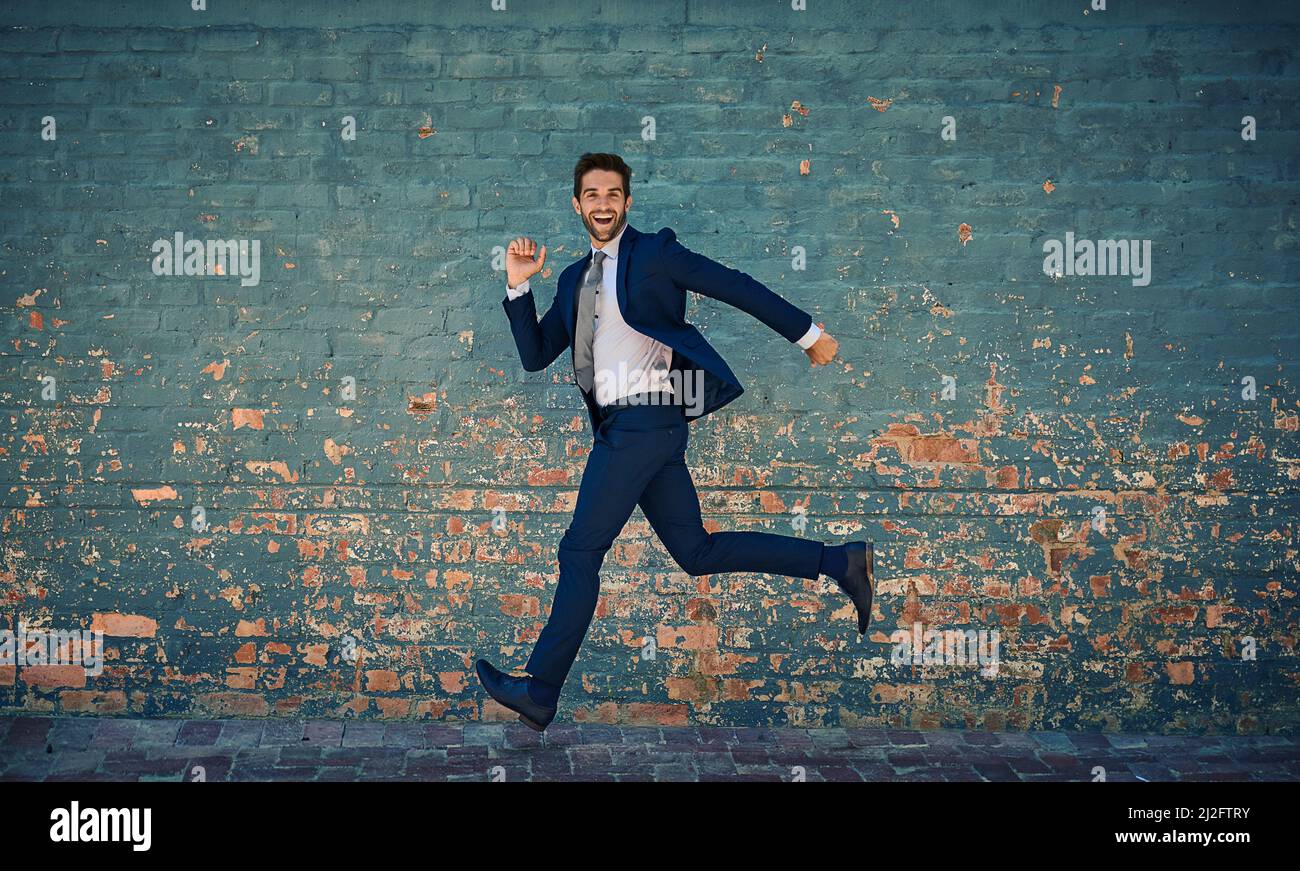 Young happy man running suit hi-res stock photography and images - Alamy