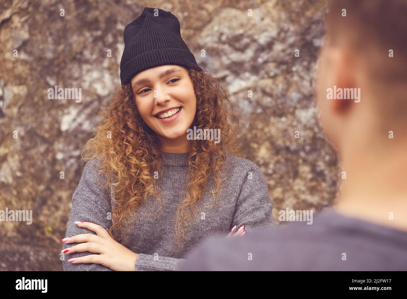 Young adult hipster woman with knit hat hanging out with friend outdoor ...