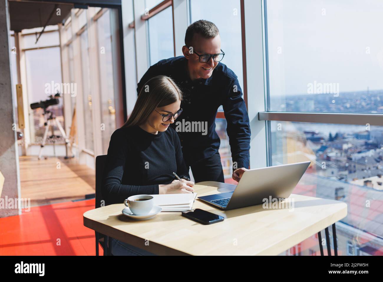 Happy business people are sitting at the table, talking, laughing ...
