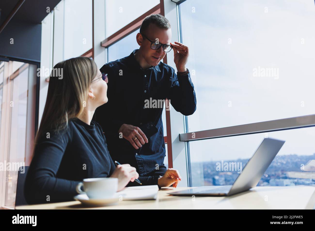 Successful business team, male and female colleagues talking at work ...