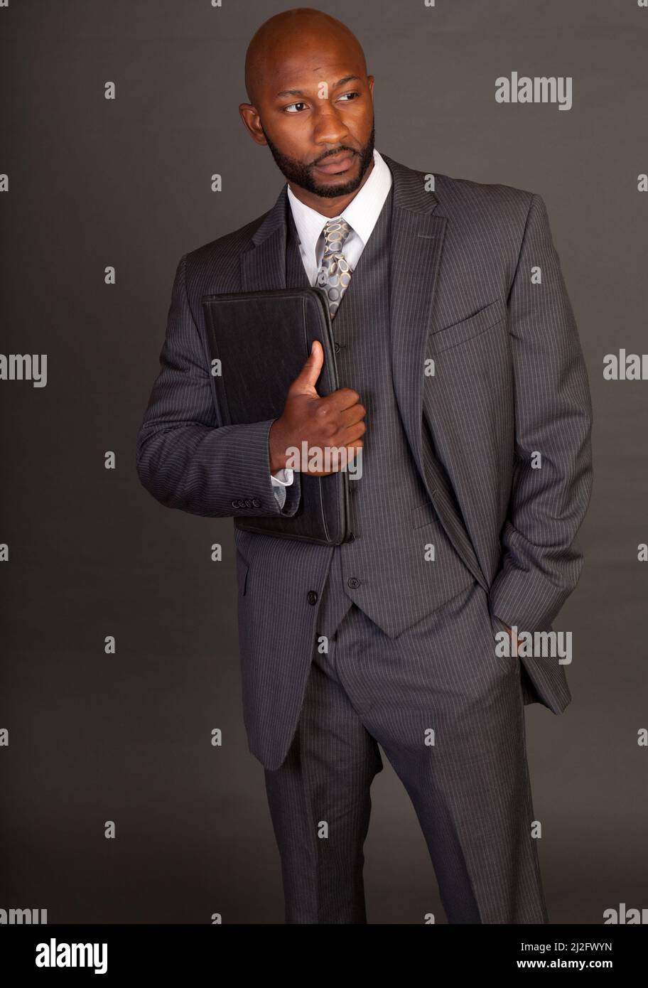 Young black business man holding a portfolio Stock Photo - Alamy