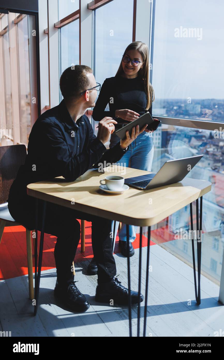 We work together on a business project. Two young business colleagues ...