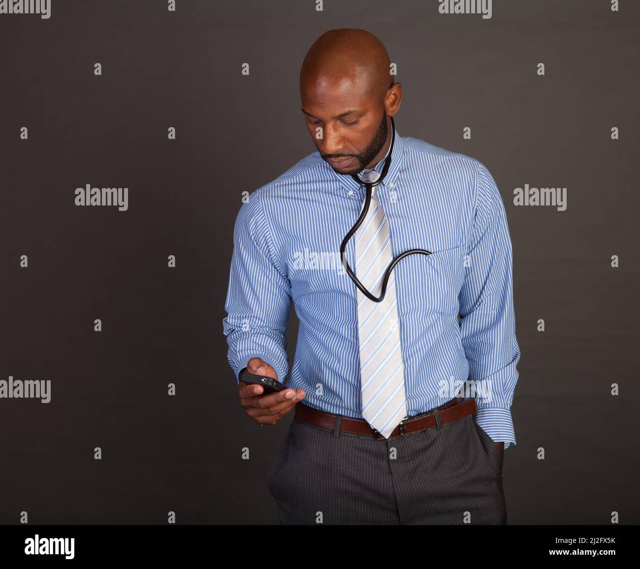 African American / Black doctor checking his cell phone Stock Photo - Alamy